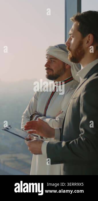 Arabic businessman talking with caucasian business partner discussing ...