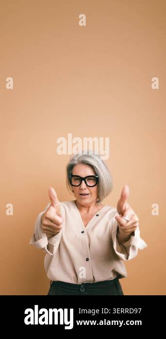 Cheerful mature businesswoman with grey hair and glasses smiling and ...