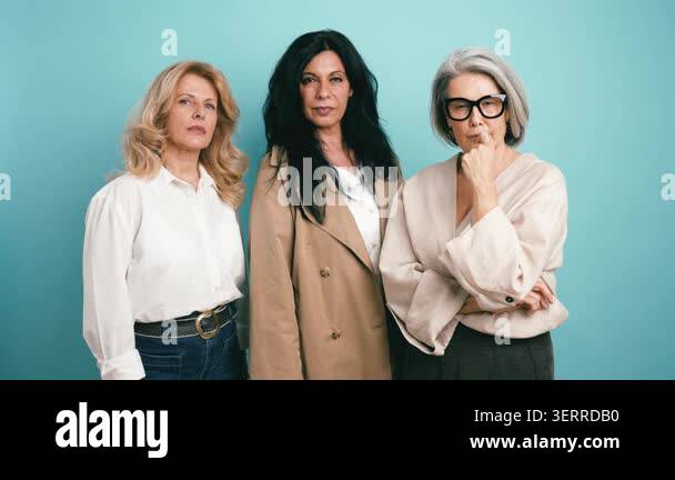 Group of three stylish and confident mature women standing together ...