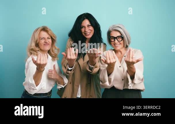 Group of stylish senior women smiling and making a beckoning hand ...