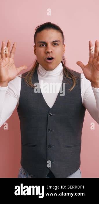Young handsome long haired man looking at the camera with a shocked ...