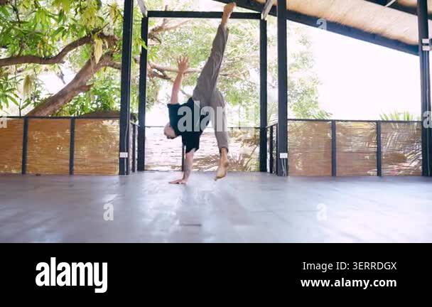 Skillful male artist performing a contemporary dance routine in a ...