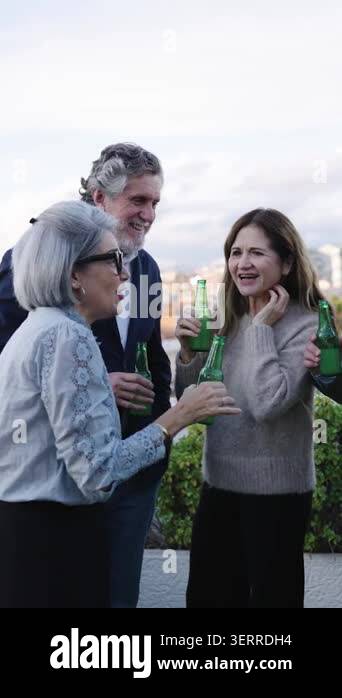 Group of happy senior friends toasting and celebrating together ...
