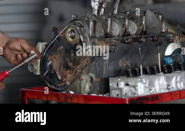 Close up shot of auto mechanic hands using a socket wrench tool to ...
