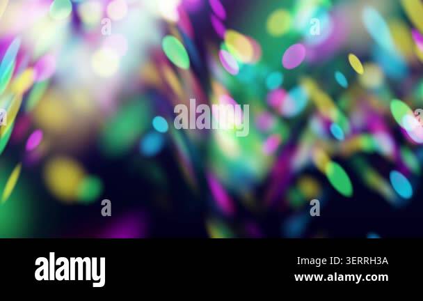 Abstract blurred multicolor light circles flowing against a dark ...