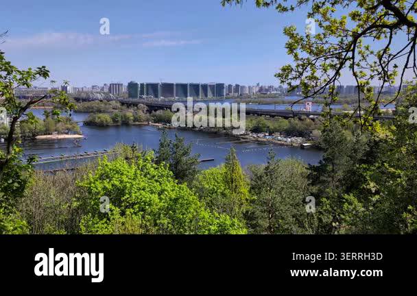Wide scenic urban landscape featuring a city skyline and long bridge ...