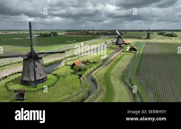 aerial footage of some traditional Dutch windmills near Schermerhorn ...