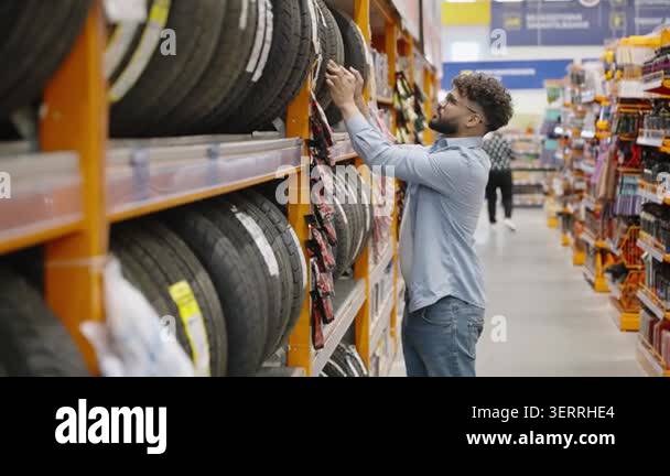 Man choosing new tires for his car in a store Stock Video Footage - Alamy