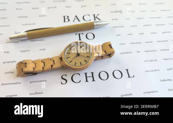 Back to School concept with wooden watch and recycled paper pen ...