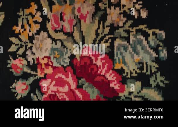 Close-up of traditional handwoven rug with intricate floral rose motifs ...