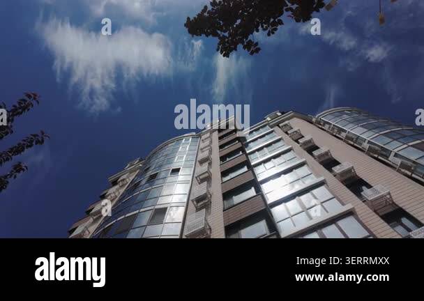 A residential building with a modern tower design above a cloudy sky ...