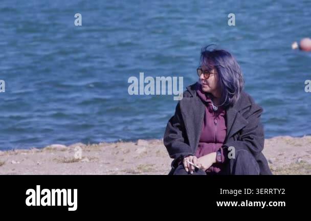 Young Woman Sits near the Sea and Road and Smoke Cigarette Stock Video ...