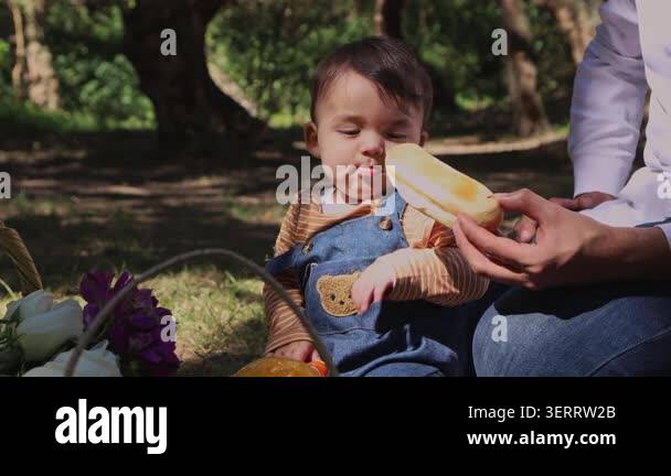 Family bonding scene featuring a father holding his baby up while ...