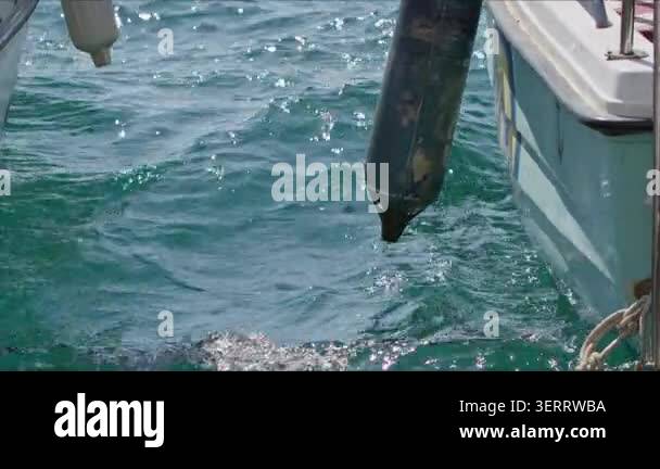 Sea Water Waves and the Fishing Boat in Dock Stock Video Footage - Alamy
