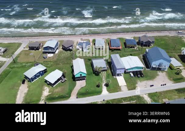 Beachfront stilt row homes near Seashell Dr line Gulf corridor beside ...