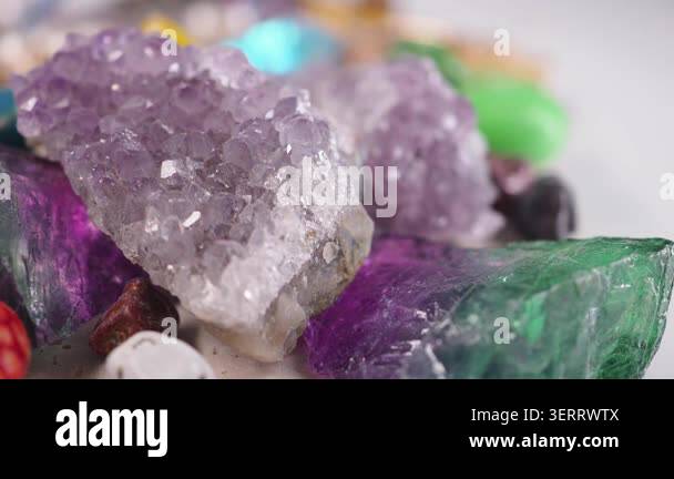 Various stones and crystals are placed on a table showing colors and ...