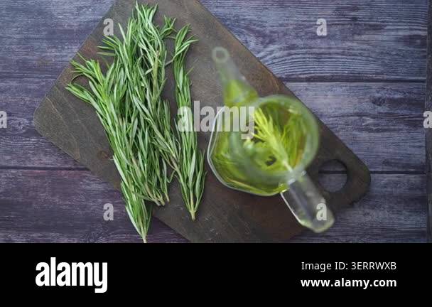 Fresh rosemary is used to create herb oil in a simple kitchen setting ...