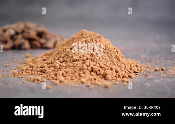 Cocoa powder is placed on a kitchen table near other cocoa products ...