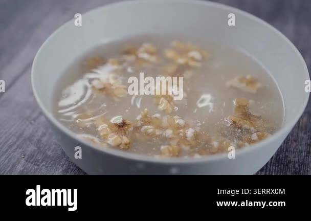 slow motion of walnuts drops in a bowl of water Stock Video Footage - Alamy