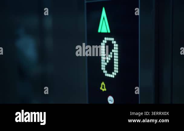 An elevator indicator shows going up and down in a tall building Stock ...