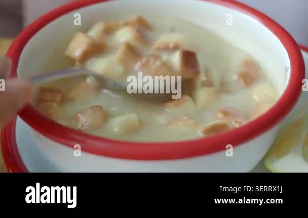 A person is eating soup at a cafe with a warm atmosphere Stock Video ...