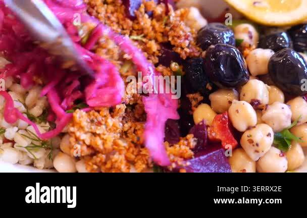 Mixing a Vibrant Healthy Salad with Chickpeas, Olives, and Pickled ...