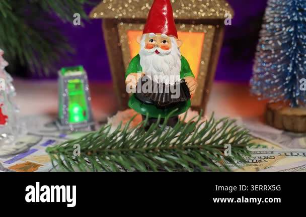 A gnome and a Christmas tree branch against a background of fir trees ...