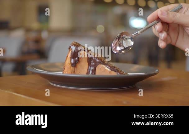 cheesecake on a grey plate, topped with chocolate syrup Stock Video ...