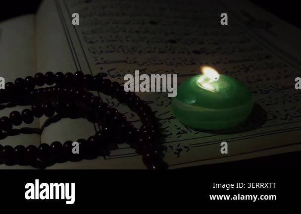 Holy Islam Muslim Book Quran and Rosary Prayer Beads in Candle Light ...