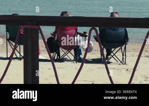 People Sitting Relaxing on the Beach Facing the Seascape View Stock ...