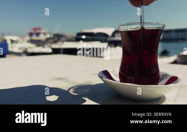 Stirring the Turkish Tea Glass on the Table by the Harbour Stock Video ...