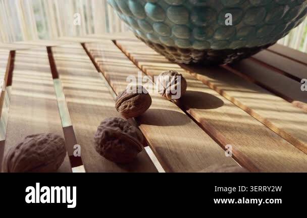 Walnut in a Ceramic Bowl on Wooden Table in Warm Sunlight Stock Video ...