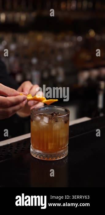 Bartender preparing a signature cocktail in a stylish moody bar Stock ...