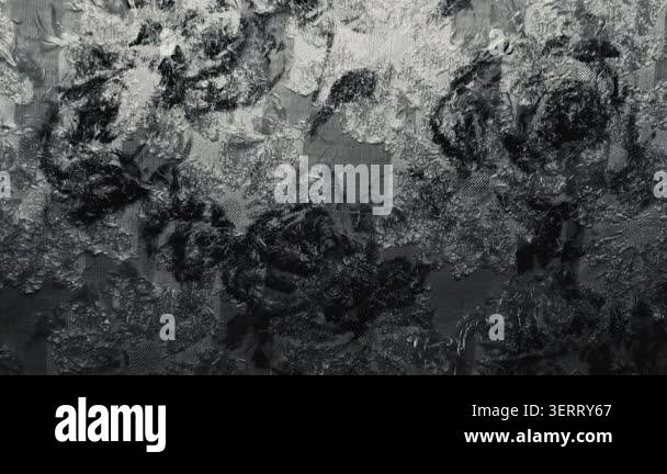 textured black and white floral jacquard fabric ripples gently under ...