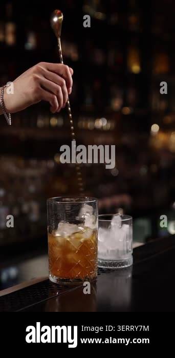 Bartender preparing a signature cocktail in a stylish moody bar Stock ...