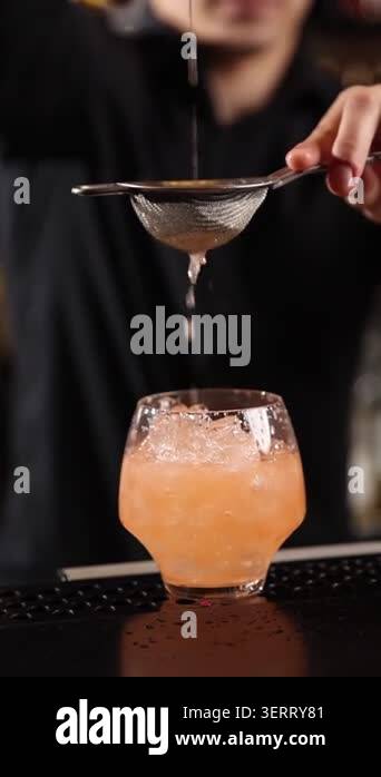 Bartender preparing a signature cocktail in a stylish moody bar Stock ...