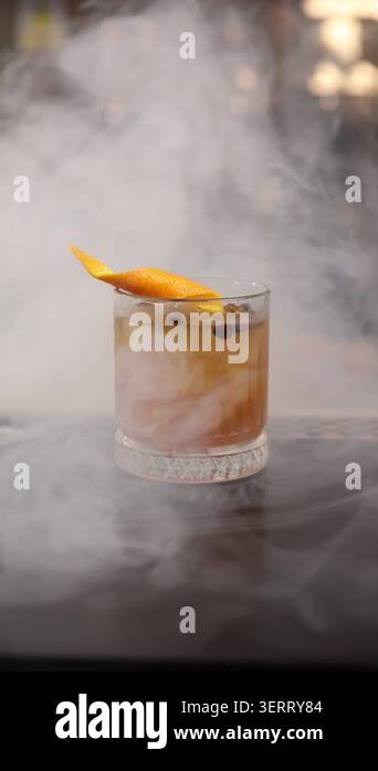 Bartender preparing a signature cocktail in a stylish moody bar Stock ...
