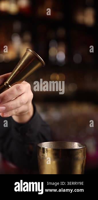 Bartender preparing a signature cocktail in a stylish moody bar Stock ...