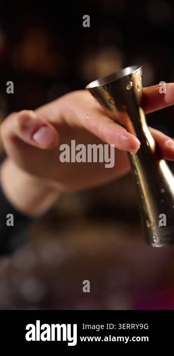 Bartender preparing a signature cocktail in a stylish moody bar Stock ...