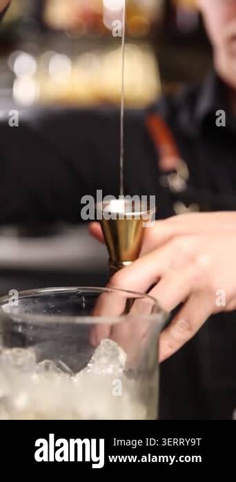 Bartender preparing a signature cocktail in a stylish moody bar Stock ...