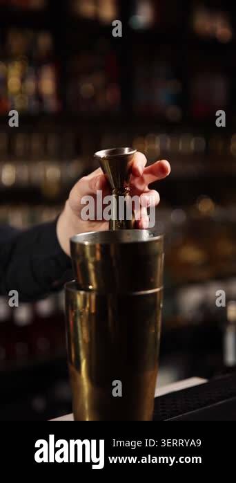 Bartender preparing a signature cocktail in a stylish moody bar Stock ...