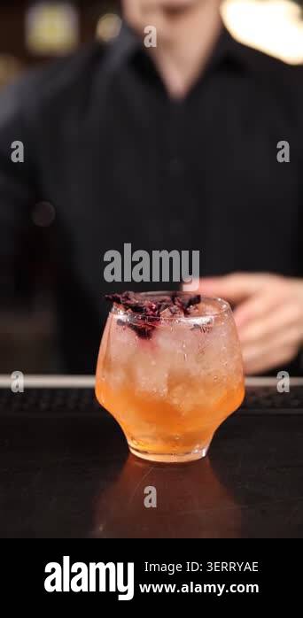 Bartender preparing a signature cocktail in a stylish moody bar Stock ...