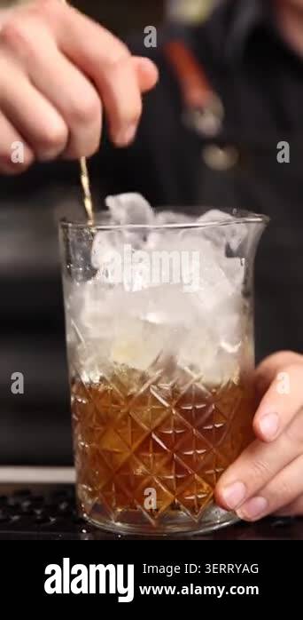 Bartender preparing a signature cocktail in a stylish moody bar Stock ...