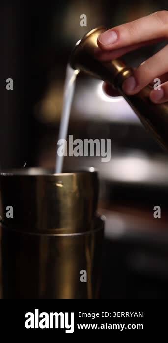 Bartender preparing a signature cocktail in a stylish moody bar Stock ...