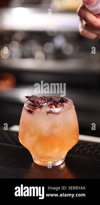 Bartender preparing a signature cocktail in a stylish moody bar Stock ...
