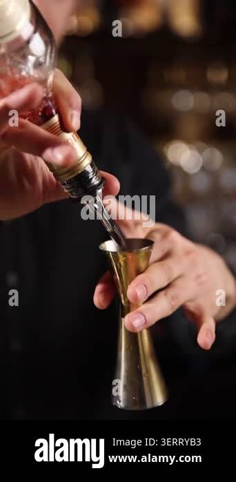 Bartender preparing a signature cocktail in a stylish moody bar Stock ...