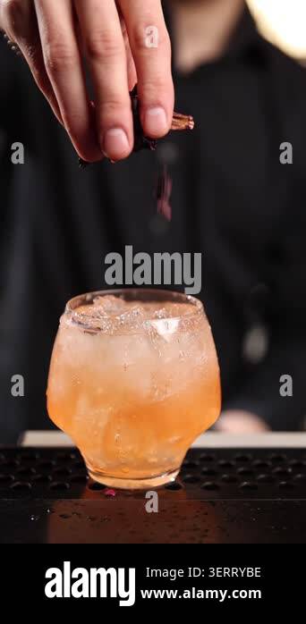 Bartender preparing a signature cocktail in a stylish moody bar Stock ...