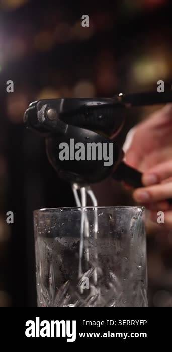 Bartender preparing a signature cocktail in a stylish moody bar Stock ...