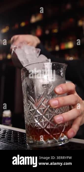 Bartender preparing a signature cocktail in a stylish moody bar Stock ...