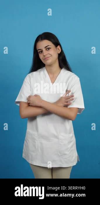 Young female medical professional in uniform crossing her arms and ...